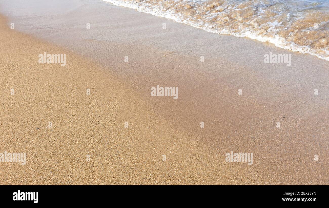 Wave on sand Stock Photo - Alamy