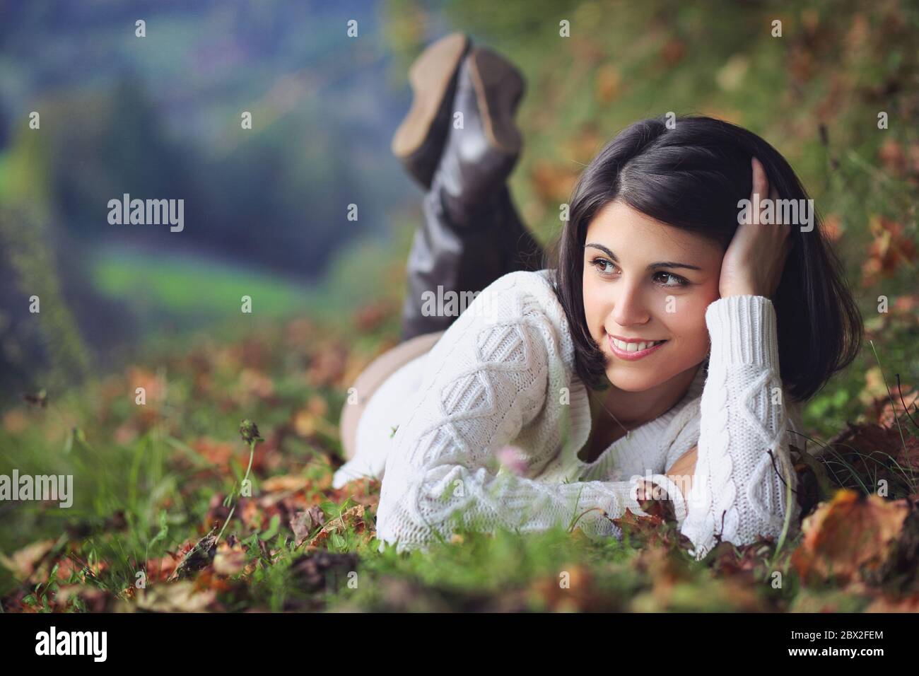 Beautiful young woman relaxing in autumn countryside . Seasonal and ...
