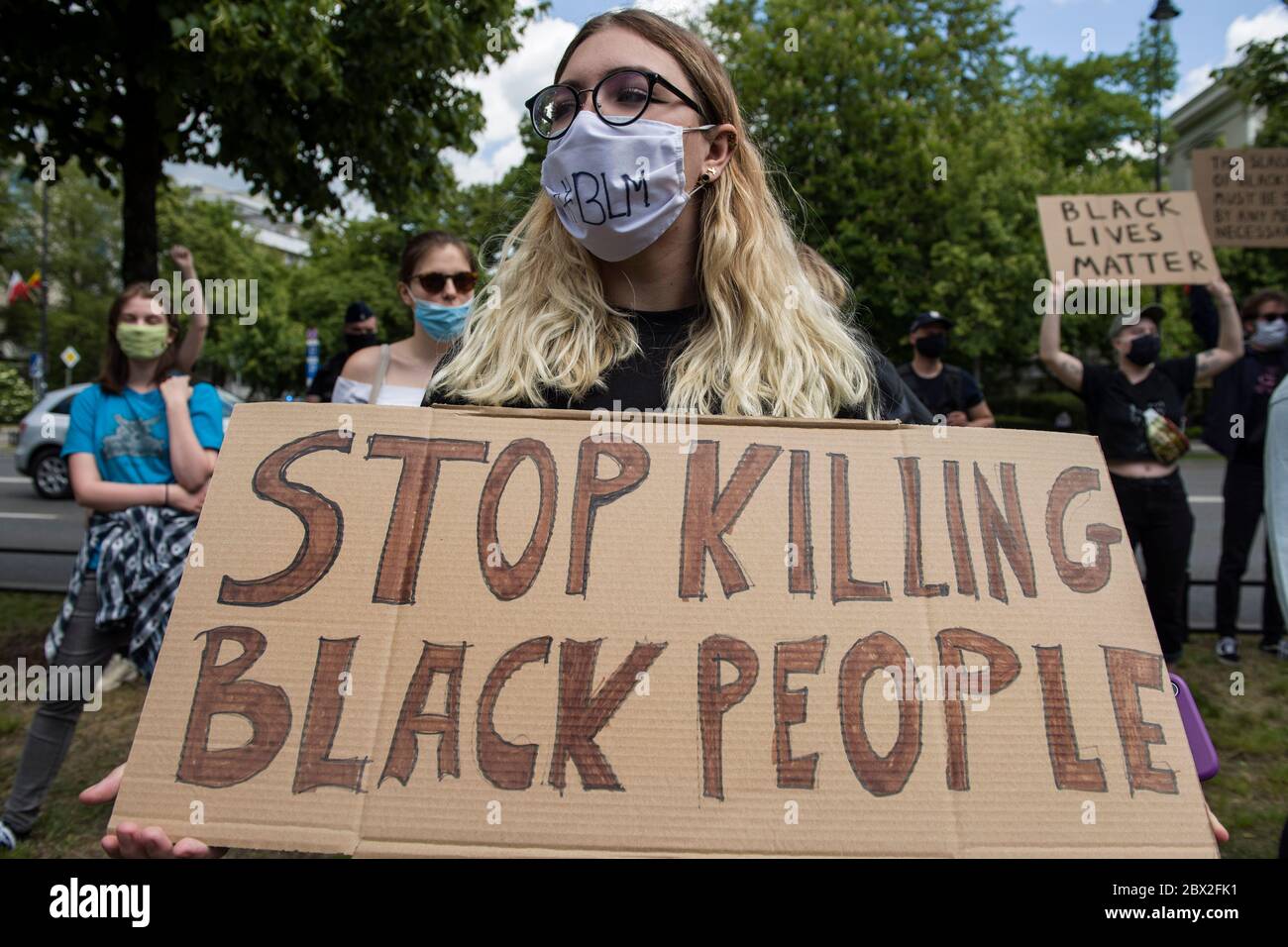 A protester holds a placard that says Stop killing black people during ...