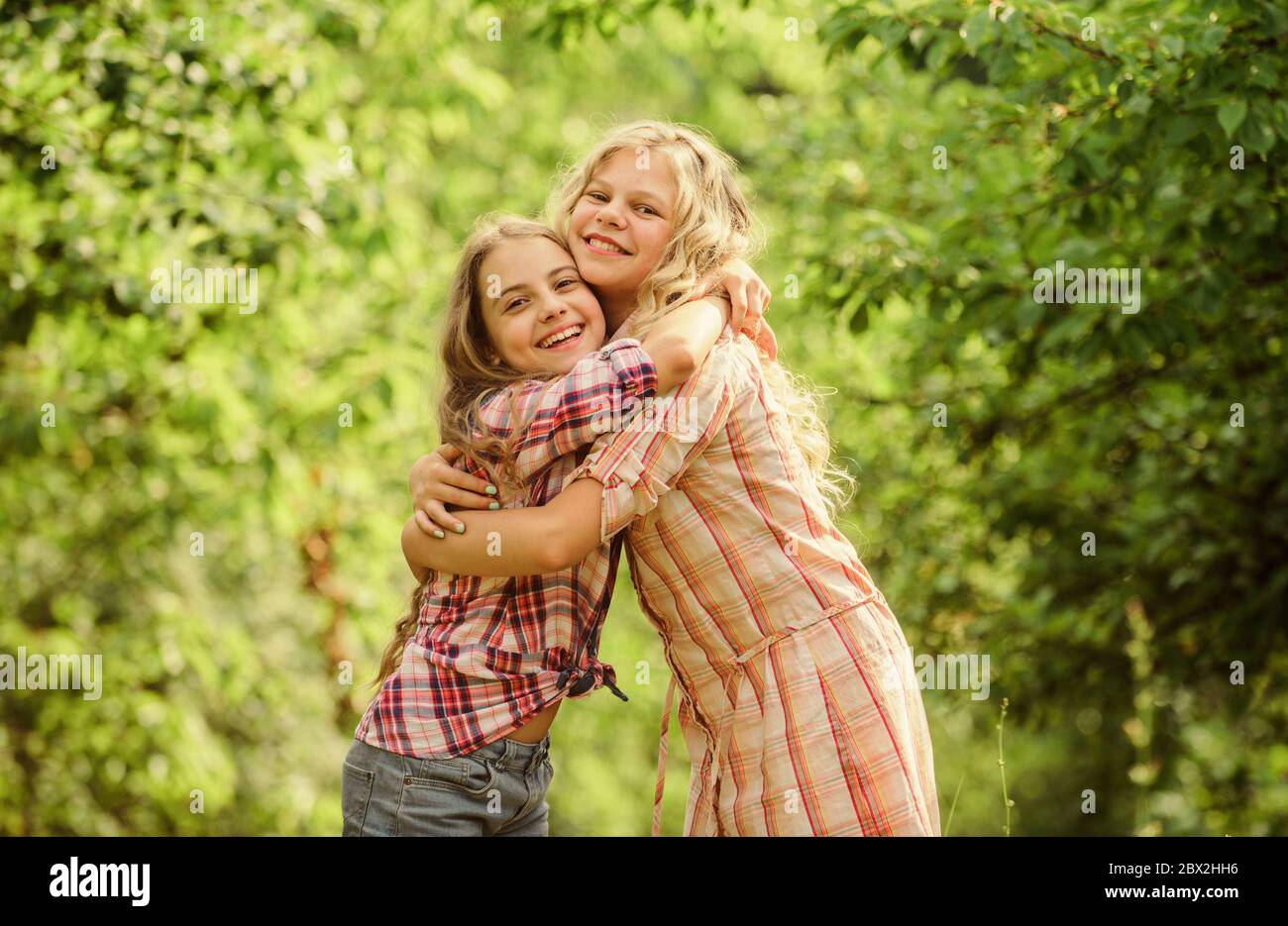 True friendship. Girls smiling happy faces hug each other. Girls ...