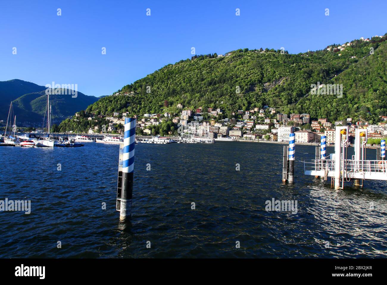 Beautiful view with mountain boat and jetty in Como lake in Italy Stock ...