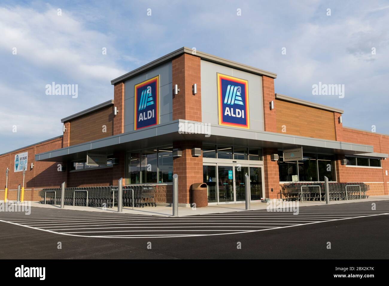 A logo sign outside of a Aldi retail grocery store location in ...