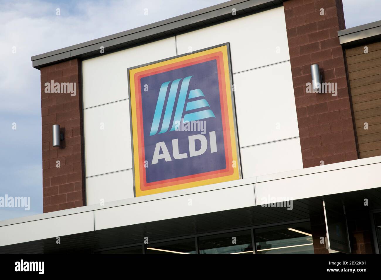 A logo sign outside of a Aldi retail grocery store location in ...