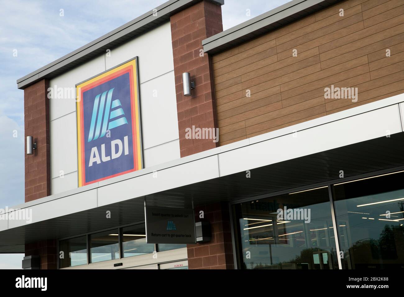 A logo sign outside of a Aldi retail grocery store location in ...