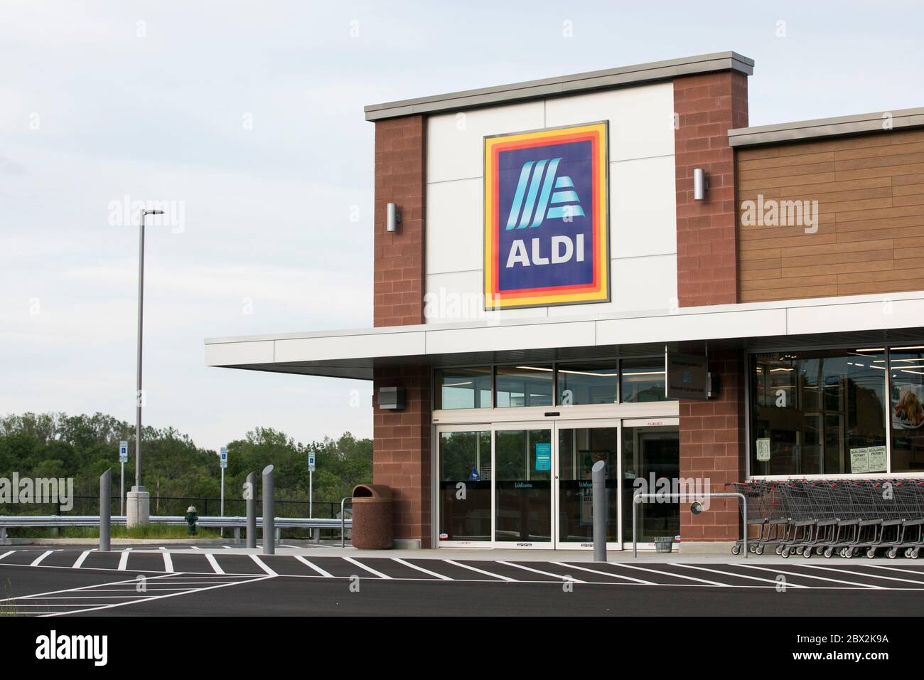 A logo sign outside of a Aldi retail grocery store location in ...