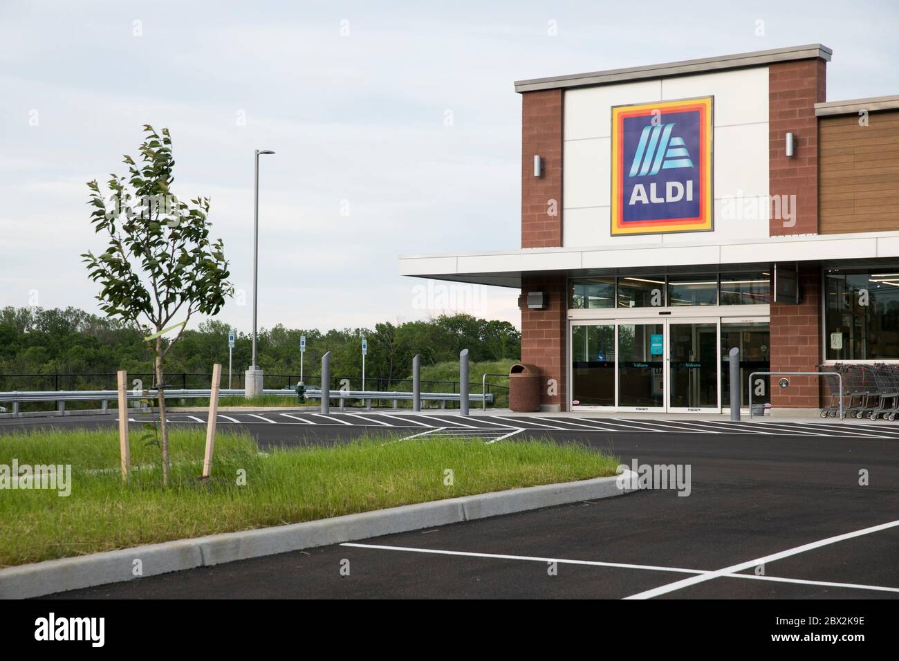 A logo sign outside of a Aldi retail grocery store location in ...