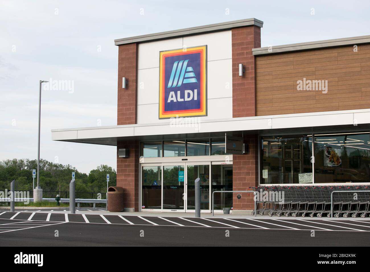 A logo sign outside of a Aldi retail grocery store location in ...