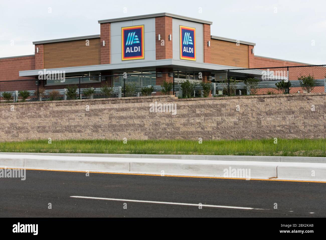 A logo sign outside of a Aldi retail grocery store location in ...