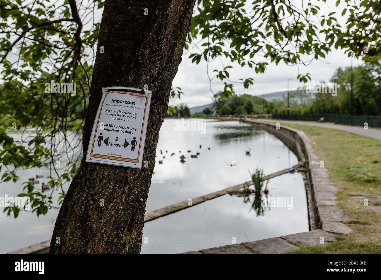 MERTHYR TYDFIL, Wales - 04 JUNE 2020 - Cyfarthfa Park lake with a sign ...