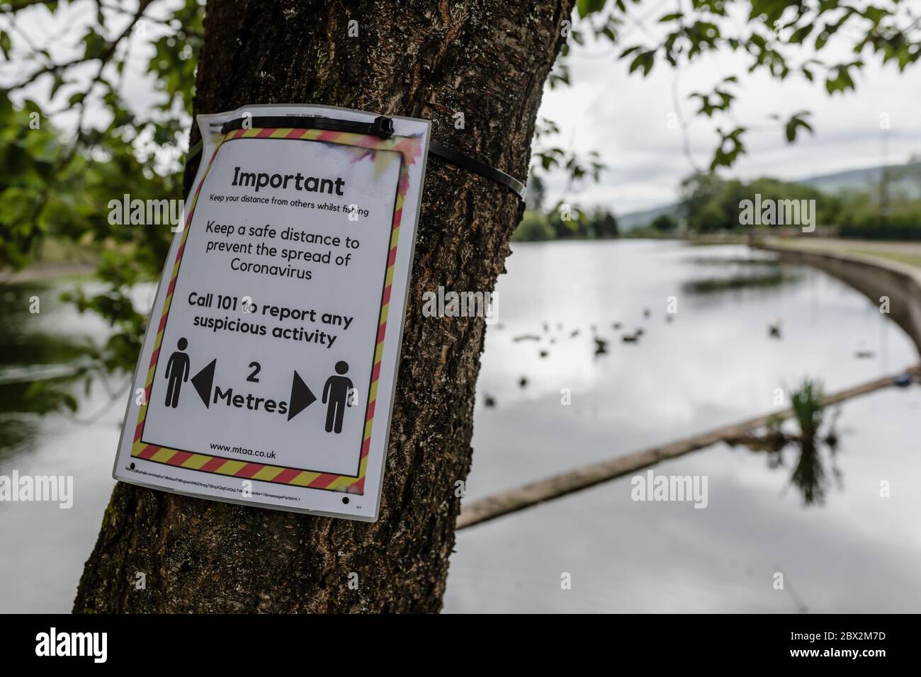 MERTHYR TYDFIL, Wales - 04 JUNE 2020 - Cyfarthfa Park lake with a sign ...