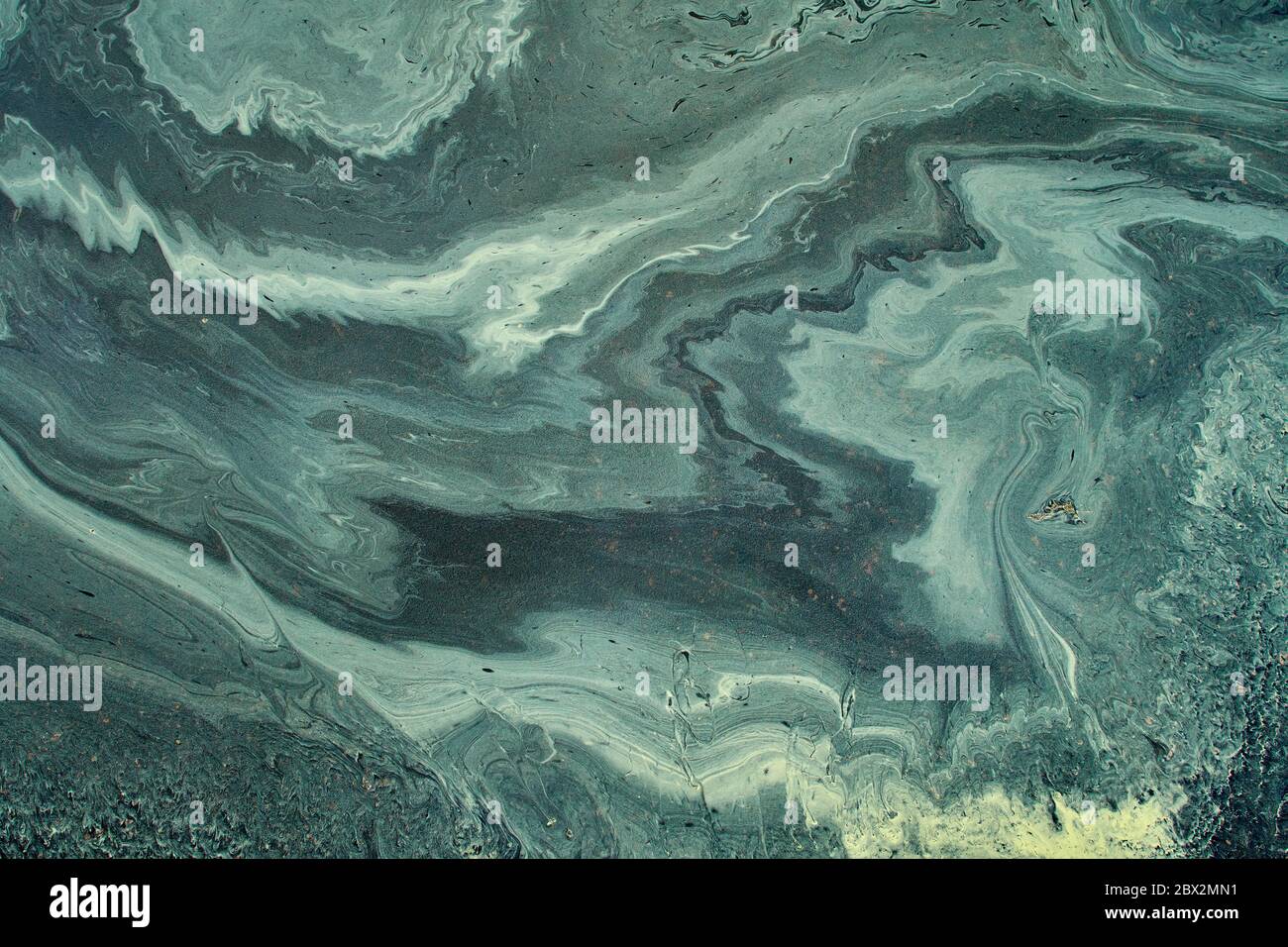 Large multi-colored stains from gasoline and shampoo, the asphalt ...