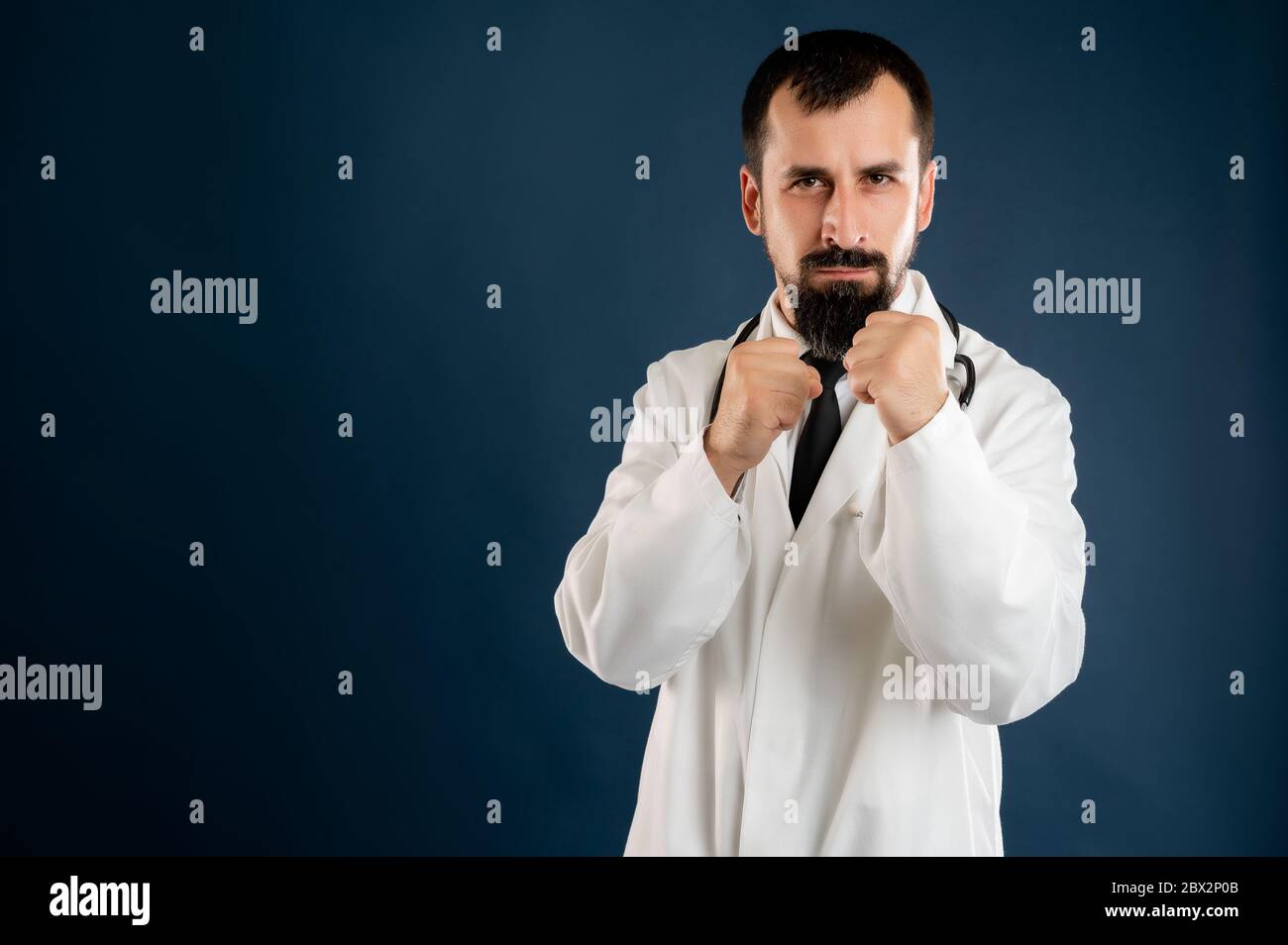 Portrait of male doctor with stethoscope in medical uniform showing ...
