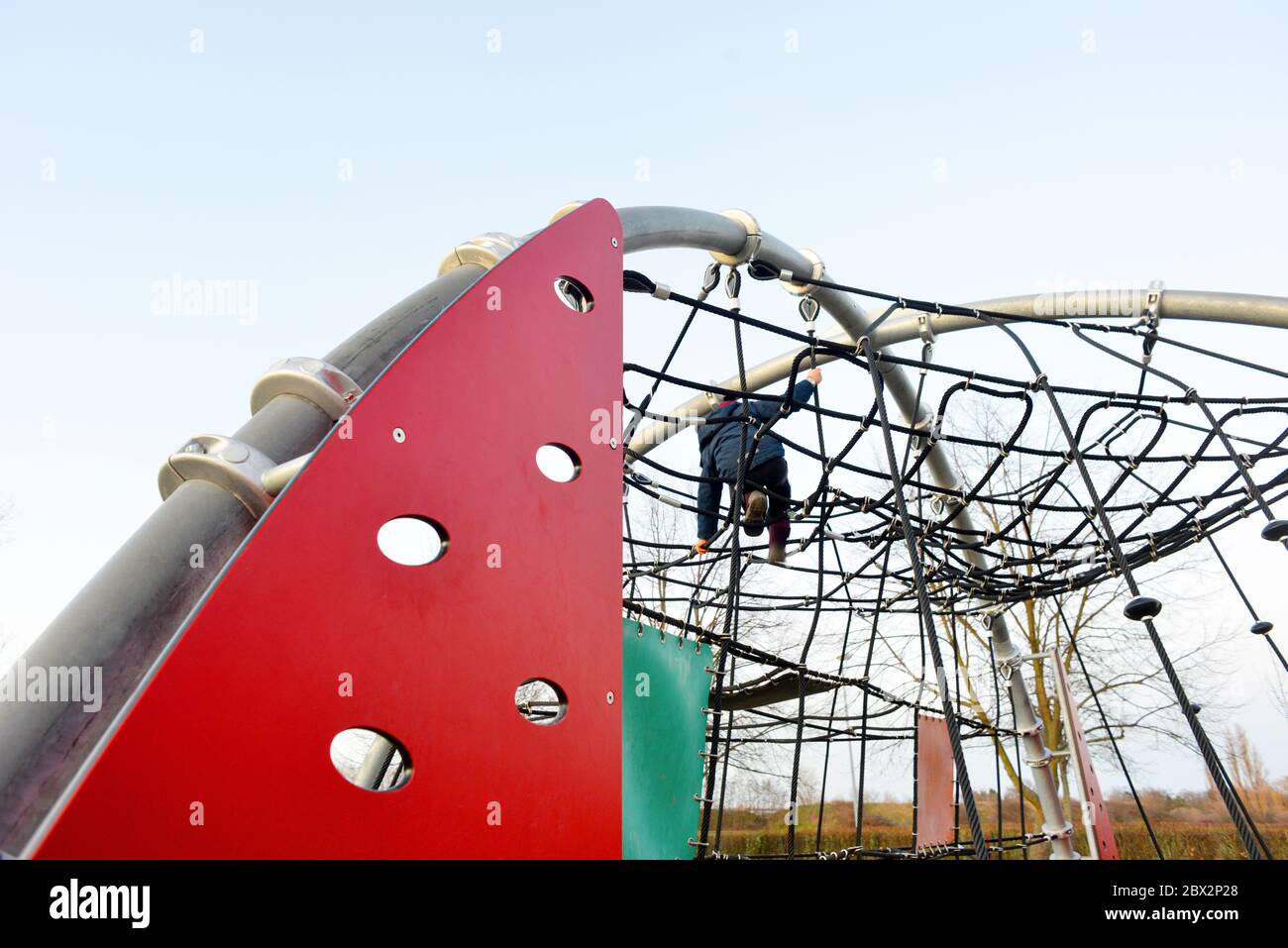 Playground outdoor and a child in action Stock Photo - Alamy