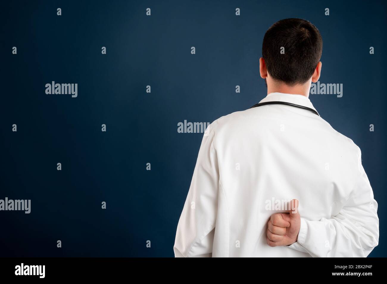 Portrait of male doctor with stethoscope in medical uniform showing ...