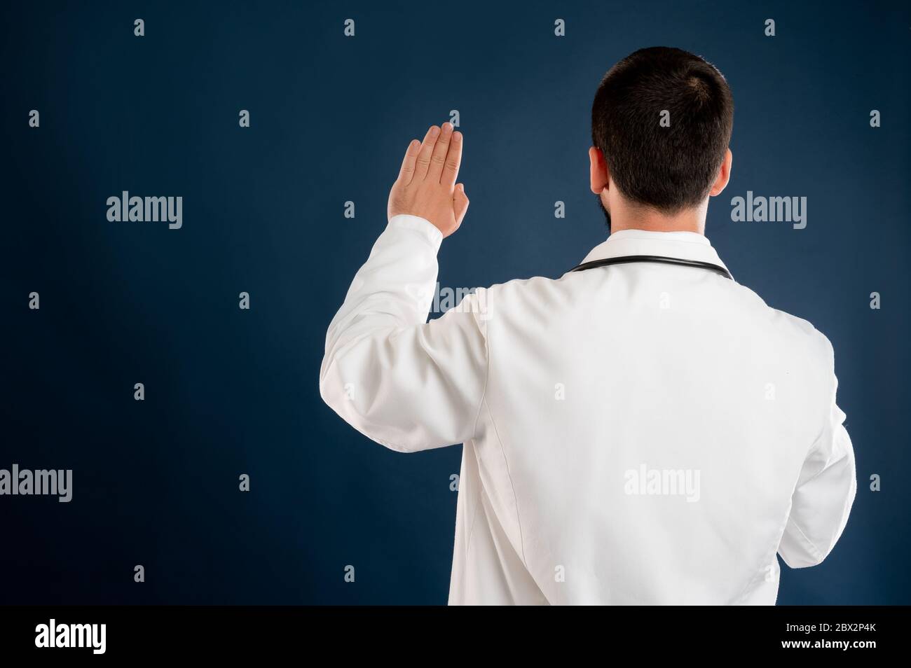 Portrait of male doctor with stethoscope in medical uniform showing ...