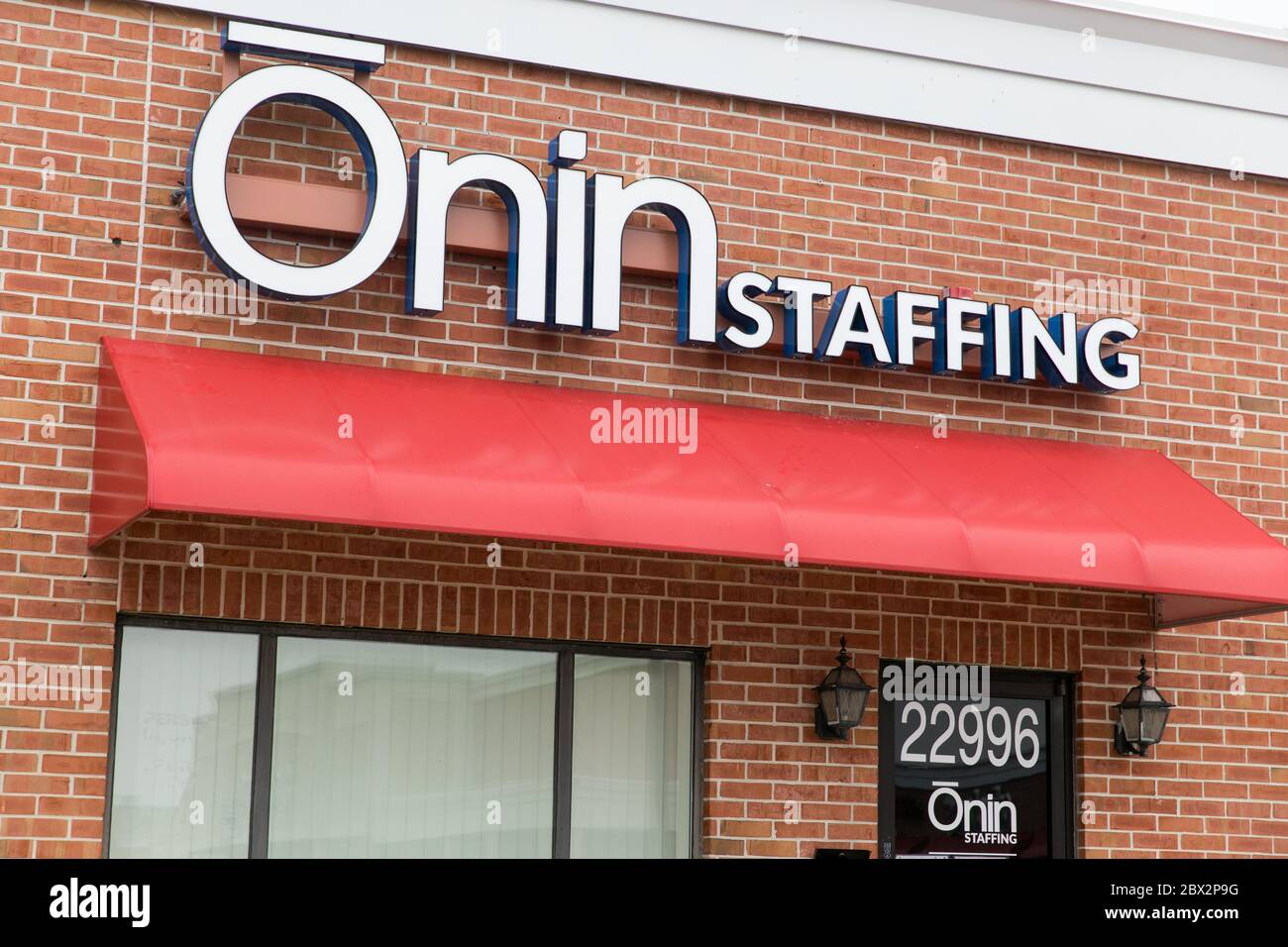A logo sign outside of a facility occupied by Onin Staffing in Seaford ...