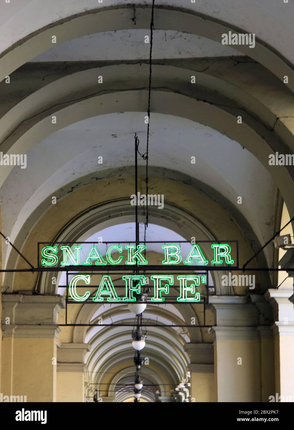 Snack Bar Cafe neon sign under arches of a building Stock Photo - Alamy