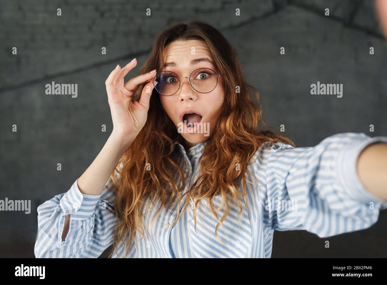 Image of shocked caucasian woman expressing surprise while taking ...