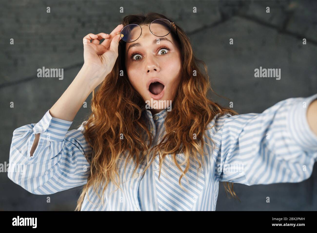 Image of shocked caucasian woman expressing surprise while taking ...