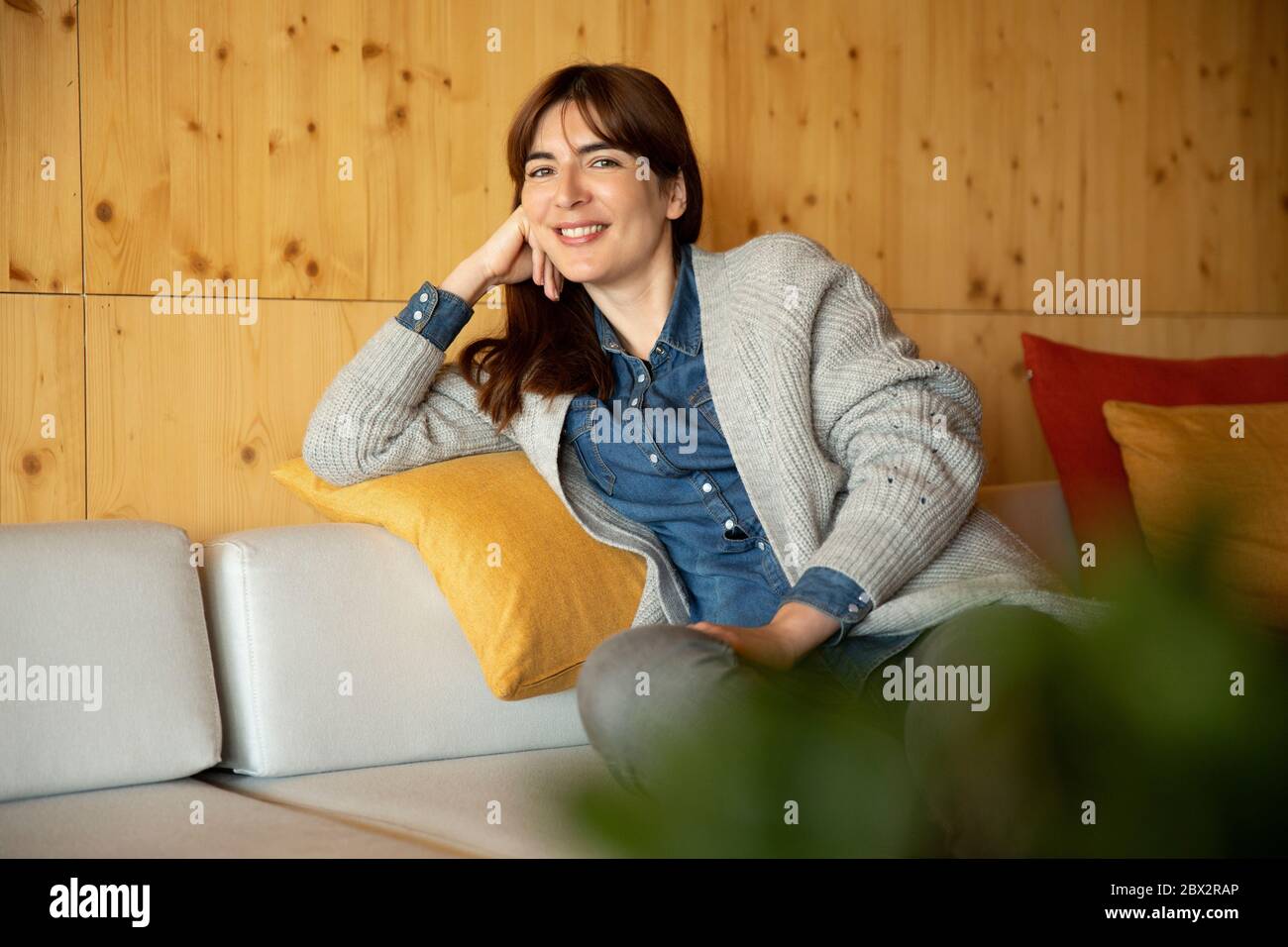 Beautiful woman sitting and relaxing Stock Photo - Alamy