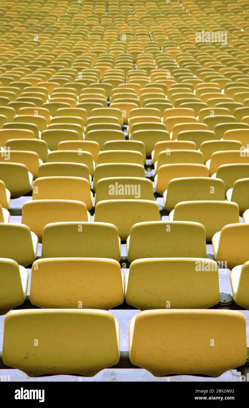 Yellow Stadium seating in rows from behind Stock Photo - Alamy