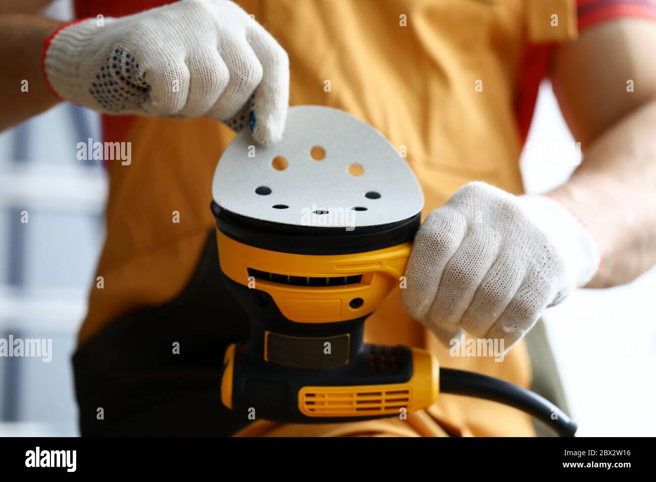 Male holding electrical tool Stock Photo - Alamy