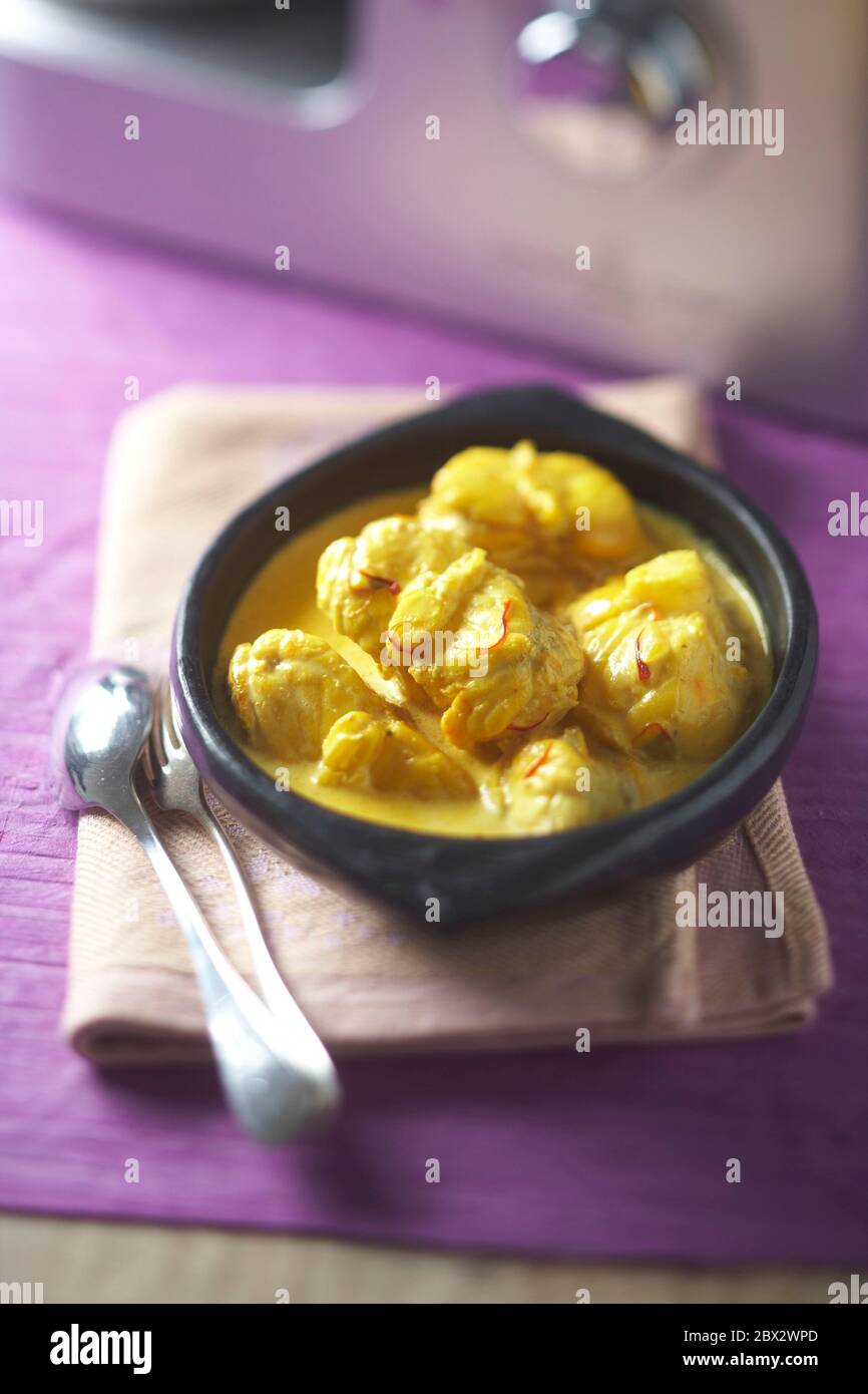 Monkfish fricassee with saffron Stock Photo - Alamy
