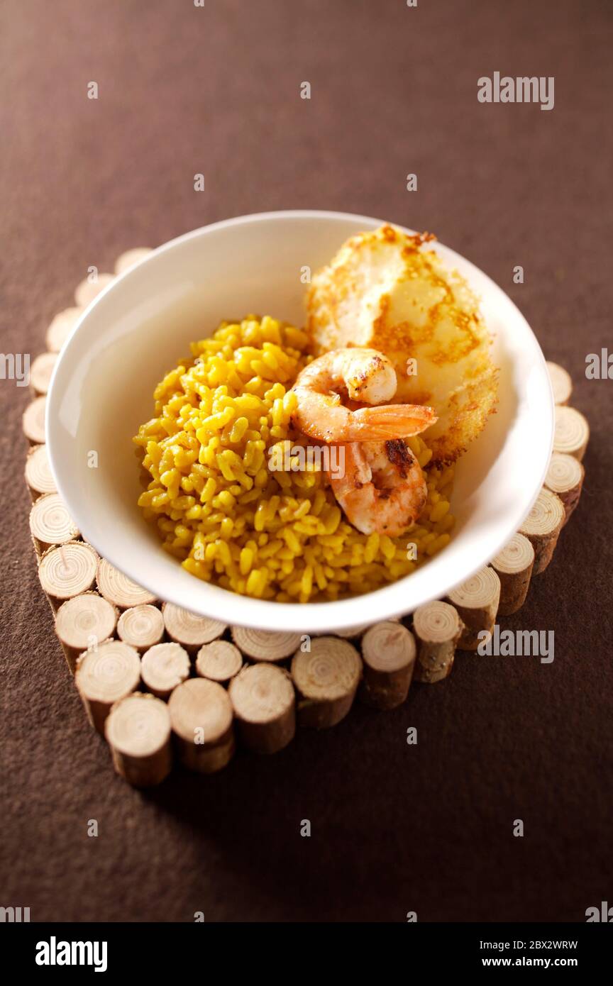 Saffron and grilled shrimp risotto, Parmesan crisps Stock Photo - Alamy
