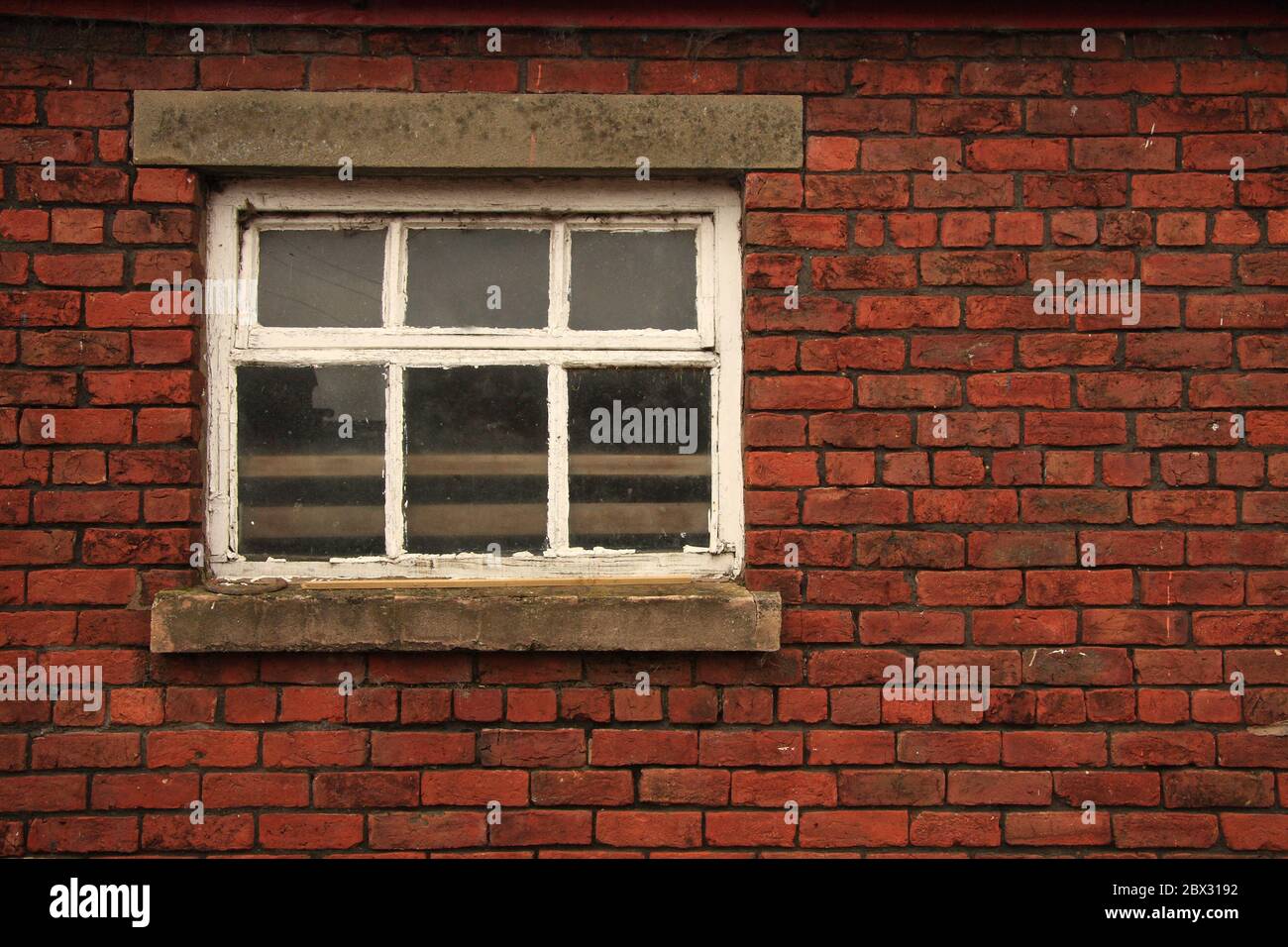 Old vintage brick wall with weathered and aged square window, stone ...