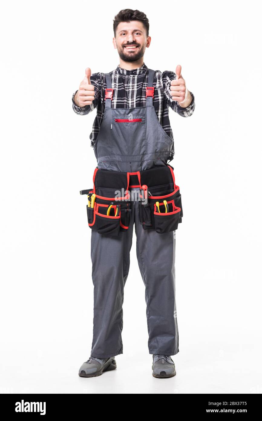 Portrait of happy handyman with tools showing thumbs up sign on white ...