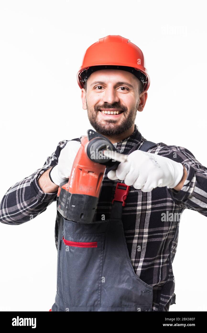 Full length portrait of a manual worker with helmet using a drill tool ...