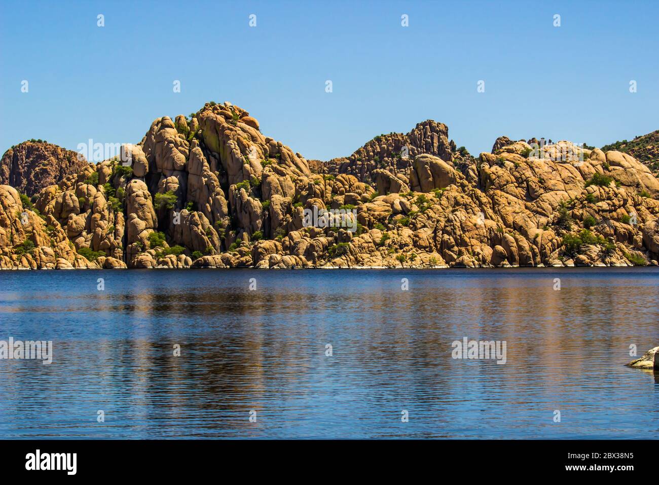 Unique Rock Shoreline At Mountain Lake Stock Photo - Alamy