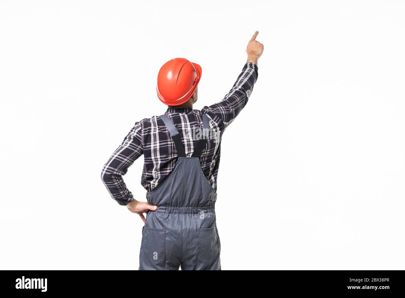 A construction man stands with his back and shows his hand. Repair and ...