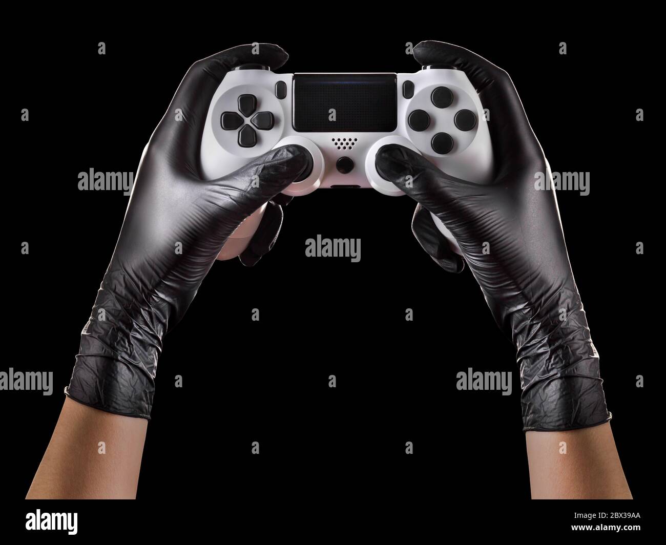 Hand in black gloves holding console gamepad isolated on black ...