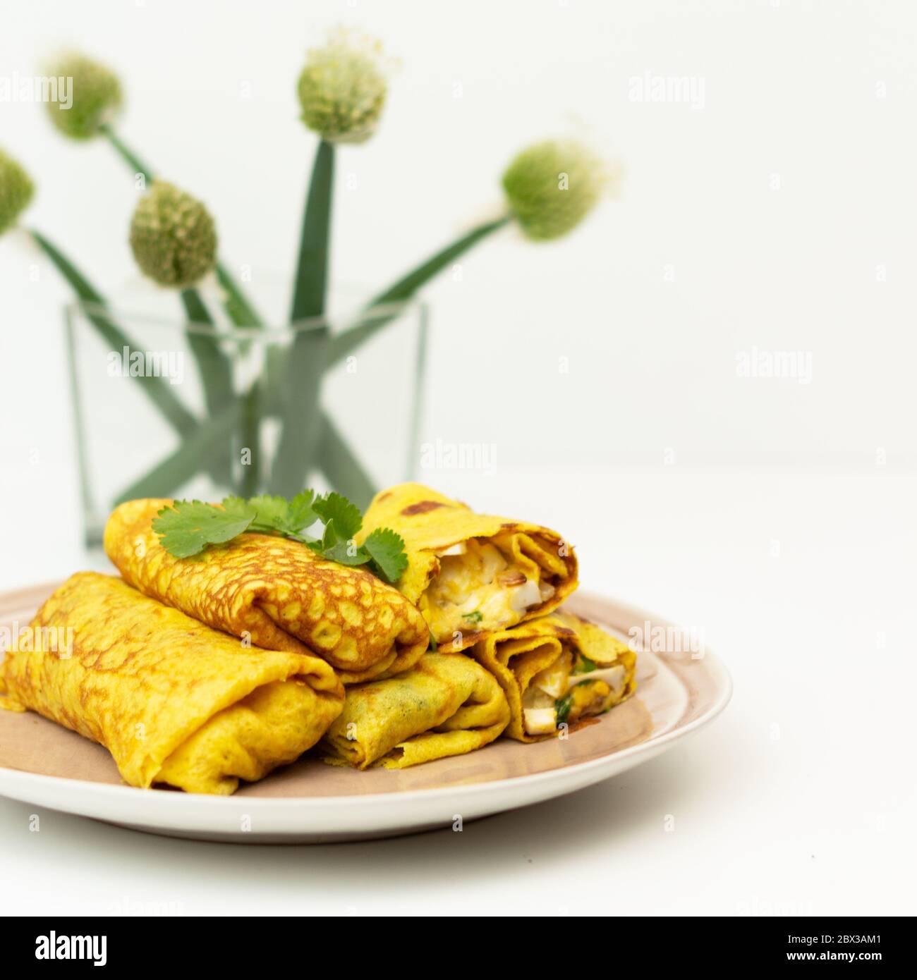 Homemade Stuffed crepes on a plate on white background Stock Photo - Alamy