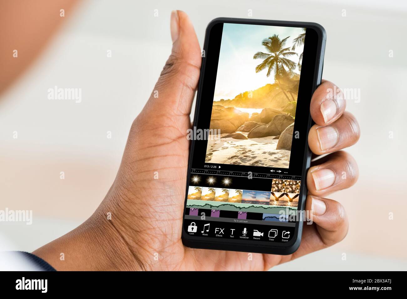 Editing Videos On Mobile Phone Using Video Editor App Stock Photo - Alamy
