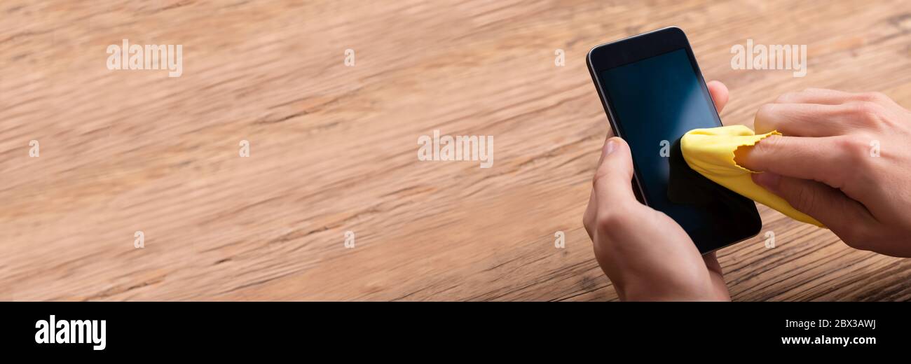 Hand Cleaning Mobile Phone Or Smartphone Screen Stock Photo - Alamy
