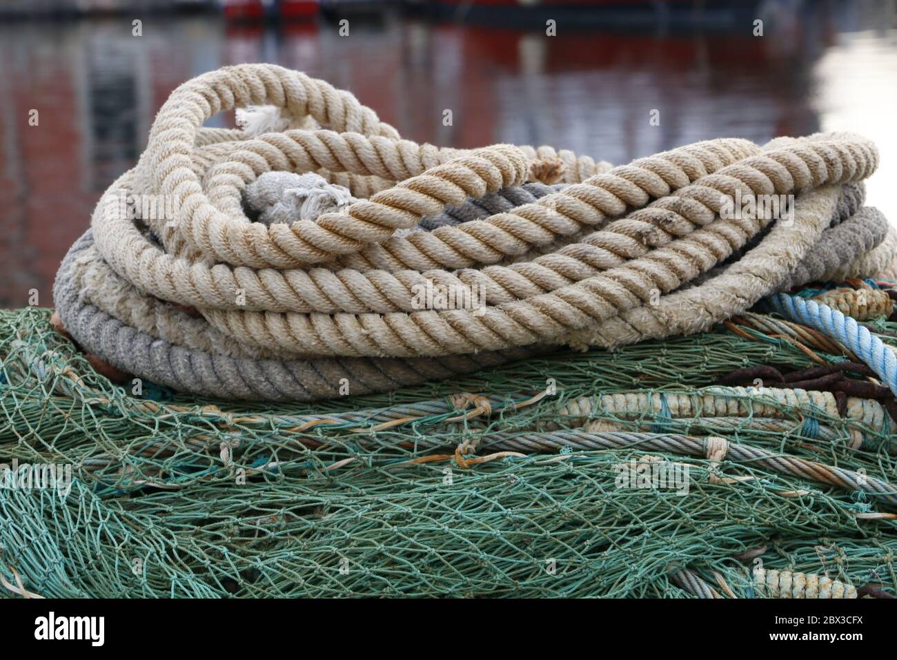 piled fishing nets and marine rope Stock Photo - Alamy
