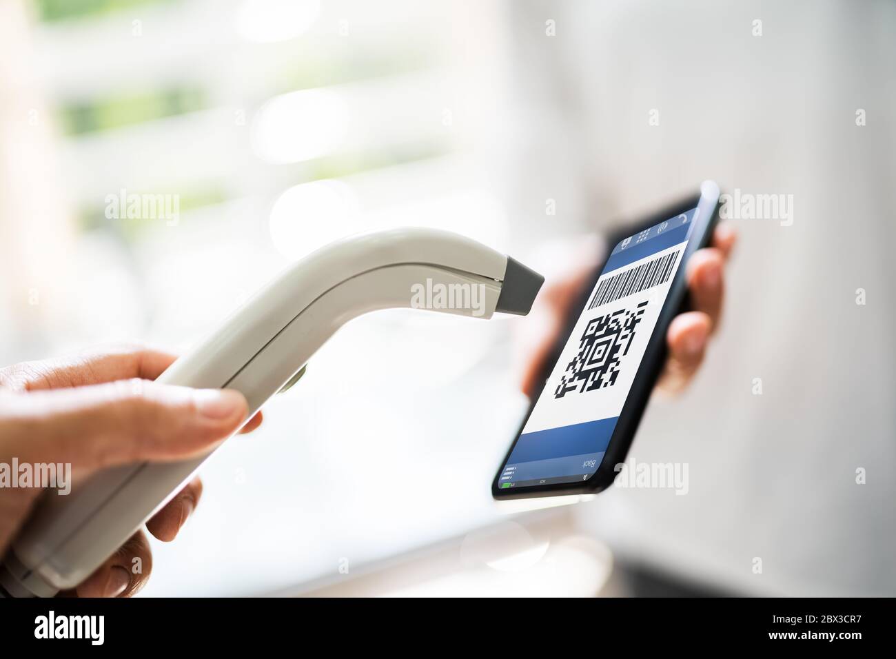 Using Mobile Phone To Scan Payment Code In Shop Stock Photo - Alamy