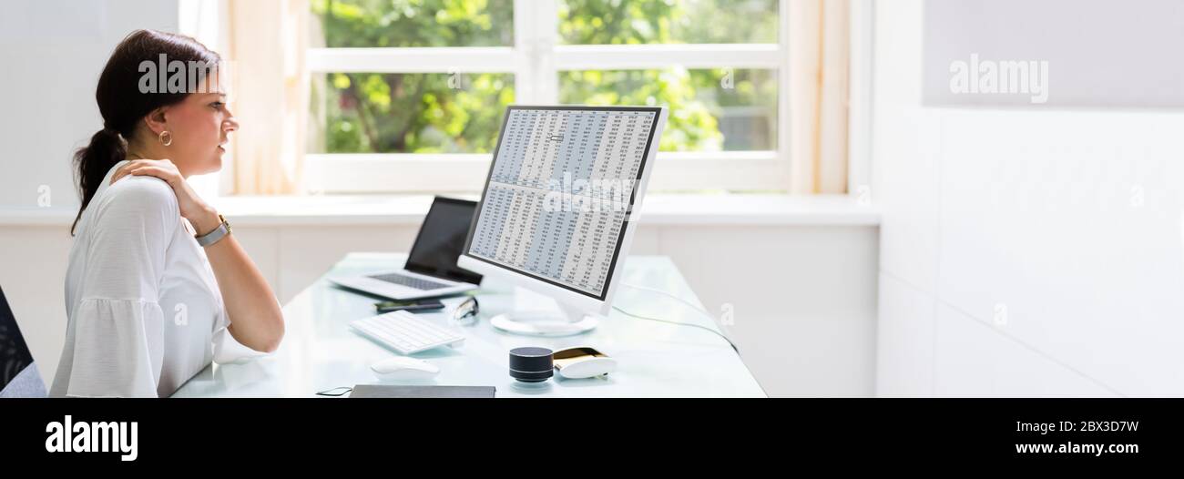 Businesswoman Having Shoulder Pain While Working At Computer Desk In ...