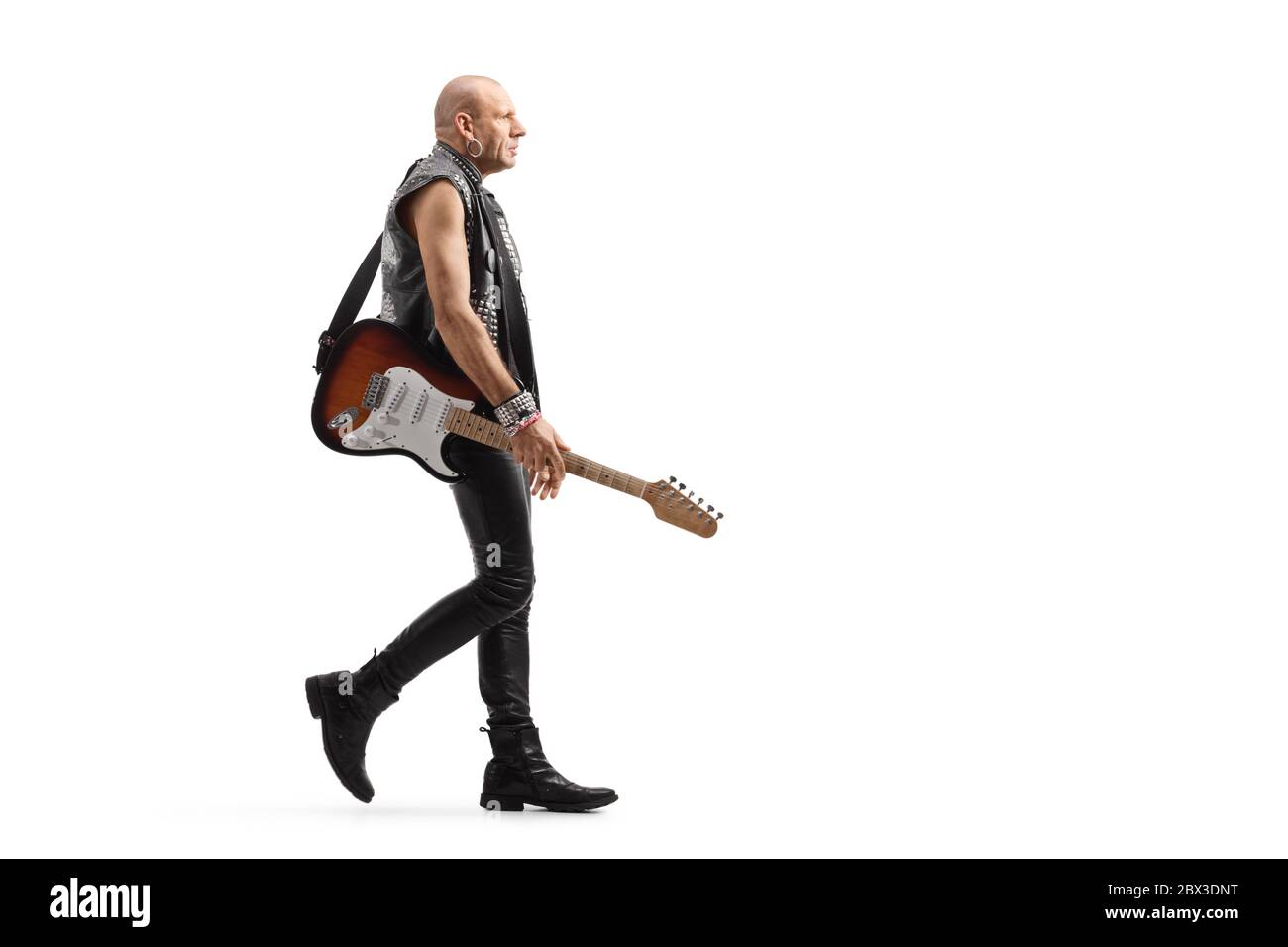 Full length profile shot of a punk rocker musician with a guitar ...