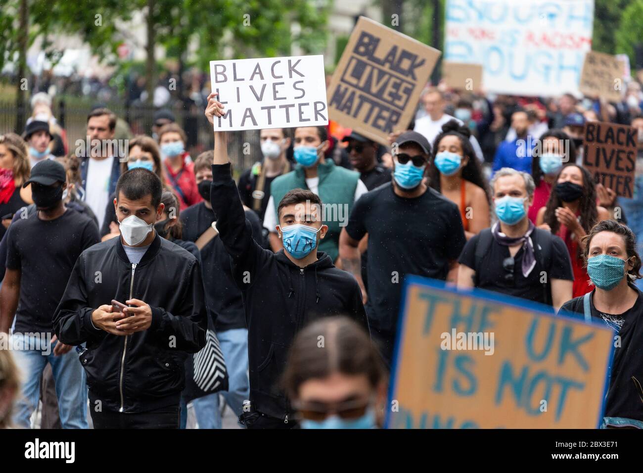 A crowd of protesters wearing face masks during the march at the Black ...