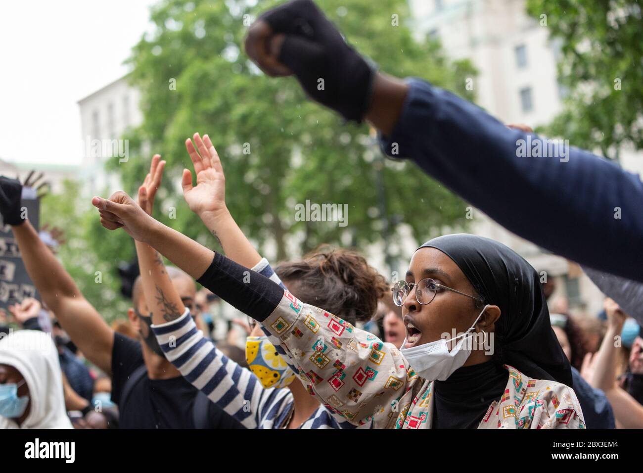 Young protesters taking the knee and raising their arms during the ...