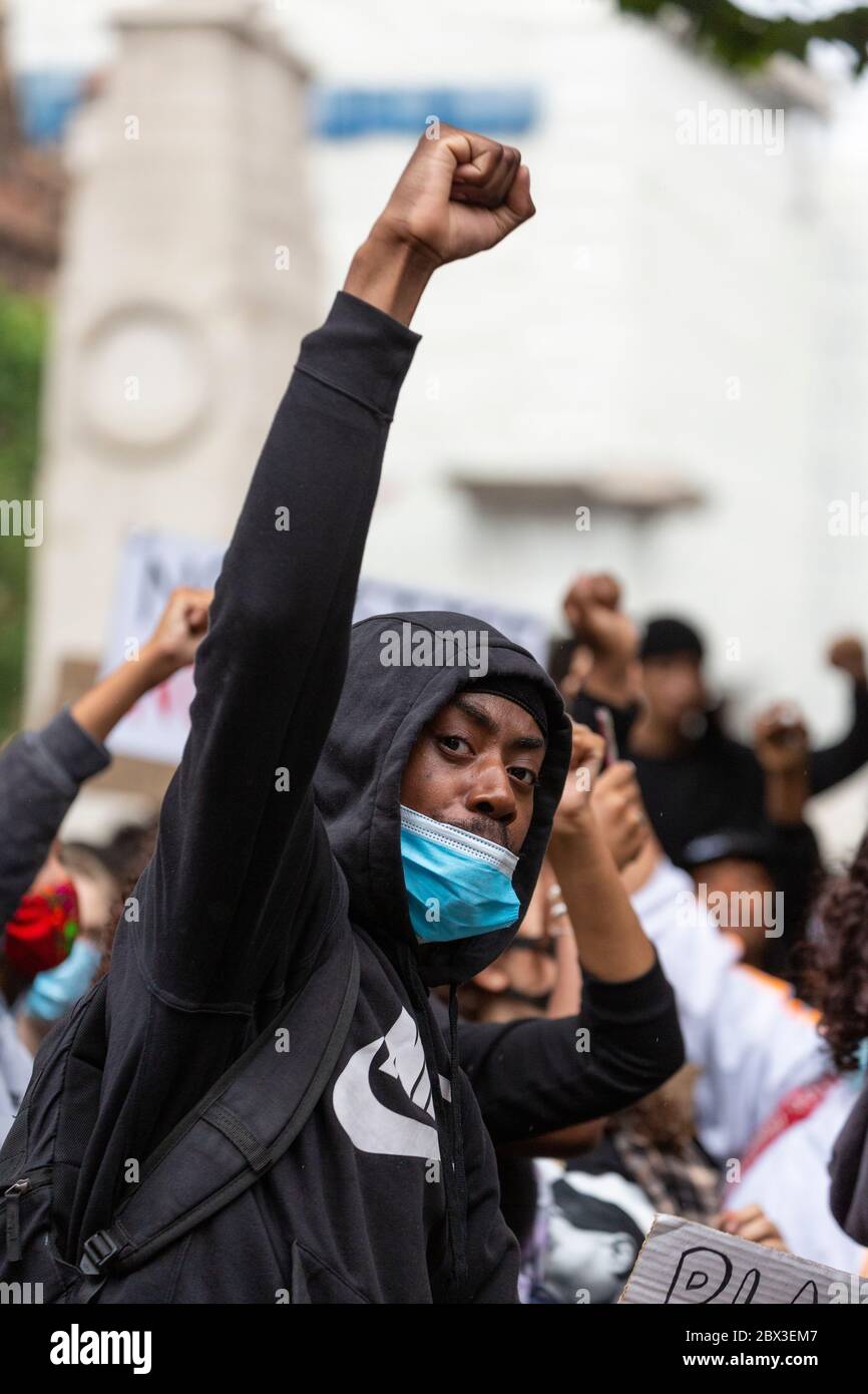 A man raises his fist while taking the knee during the Black Lives ...