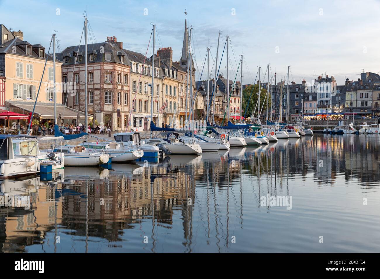 Harbor of historic city Honfleur with sailing ships and restaurants ...