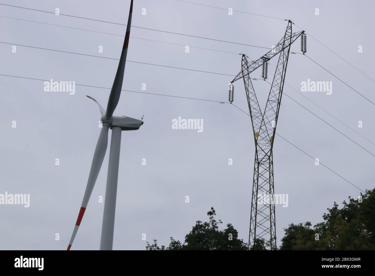 high voltage poles and wind turbine Stock Photo - Alamy