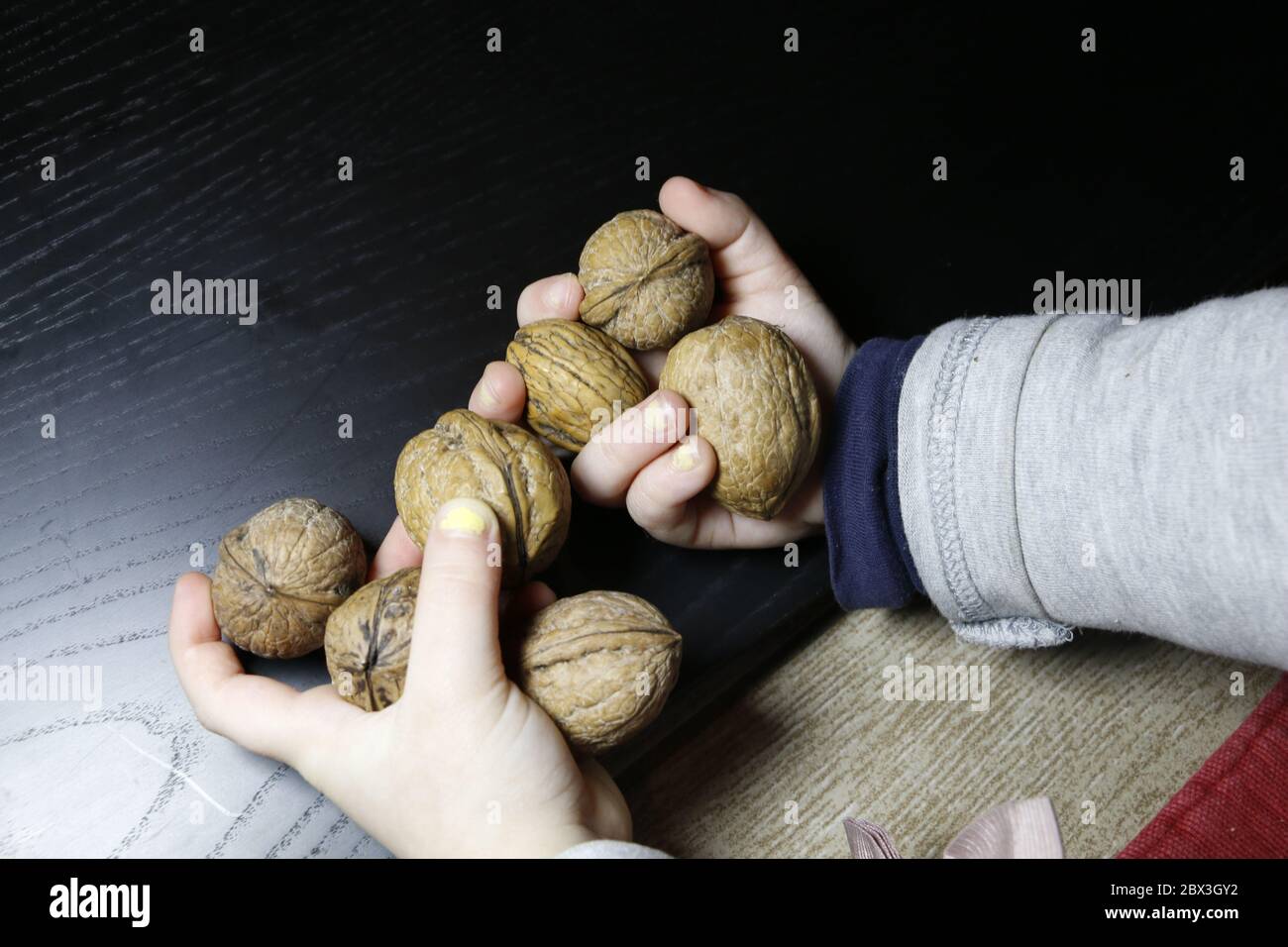 child's hands holding nuts in shell Stock Photo - Alamy