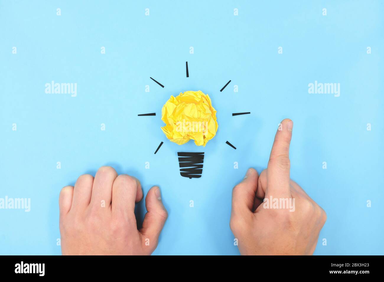 Yellow light bulb in blue background flat lay. Bright new ideas and ...