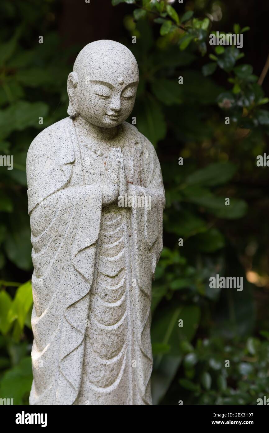 Itoman, Okinawa/Japan - 03-16-2014: A small buddha statue in front of ...