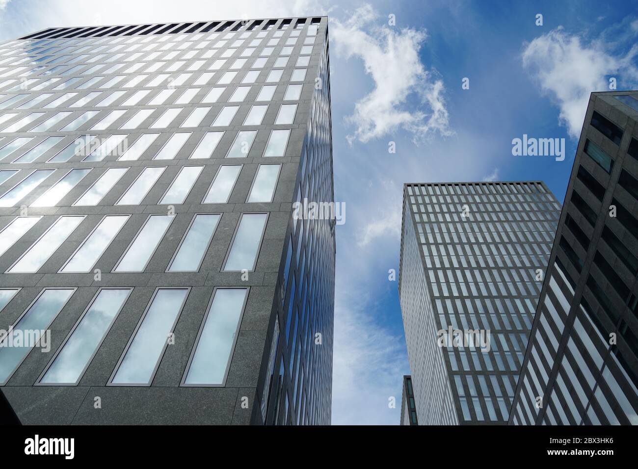 two modern office corporate buildings opposite to each other in upward ...